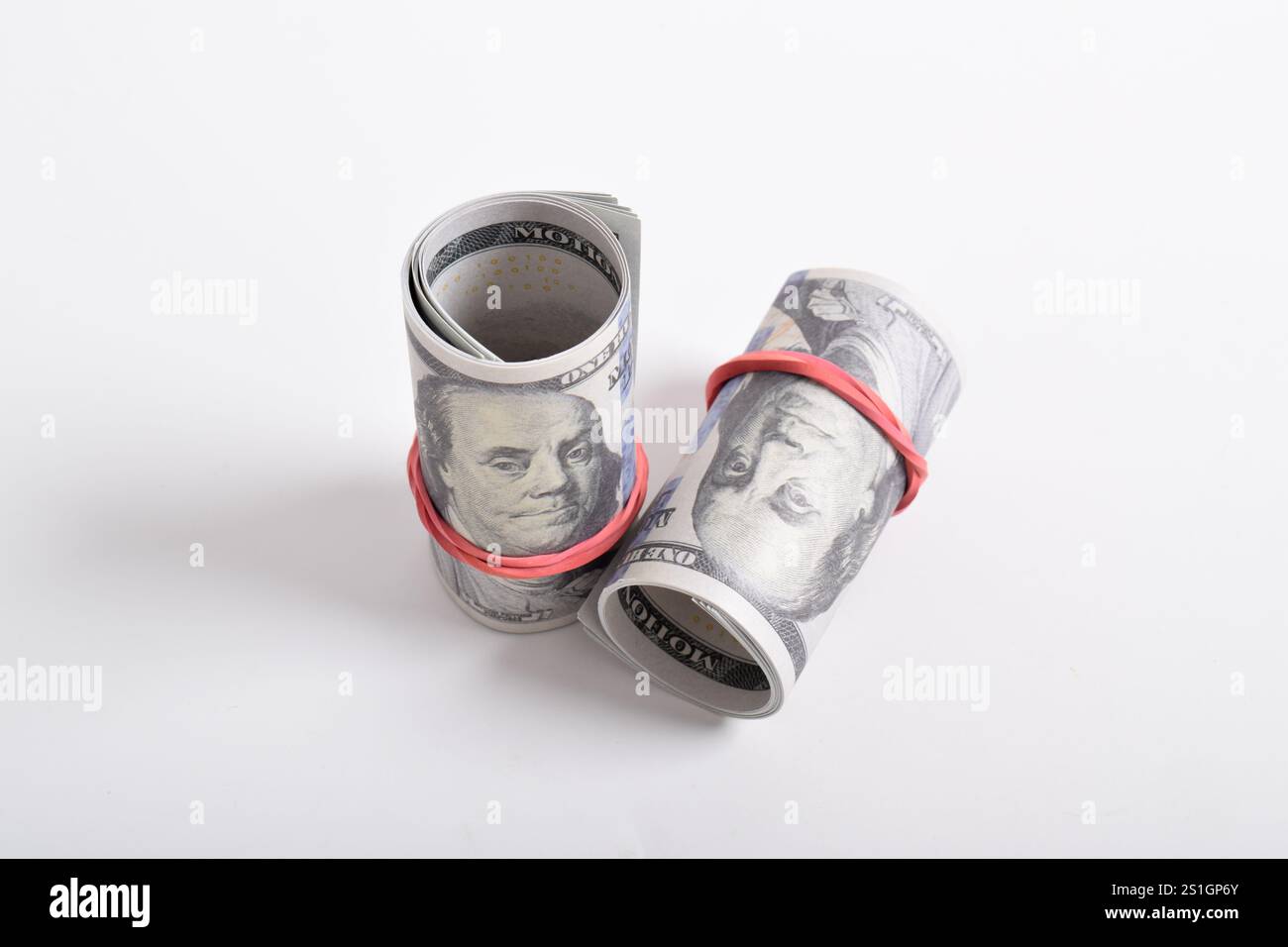 Dollar roll wrapped with red rubber. 100 dollar bills on a roll ...