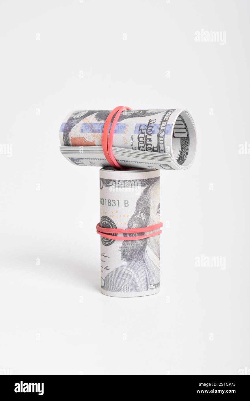 Dollar roll wrapped with red rubber. 100 dollar bills on a roll ...