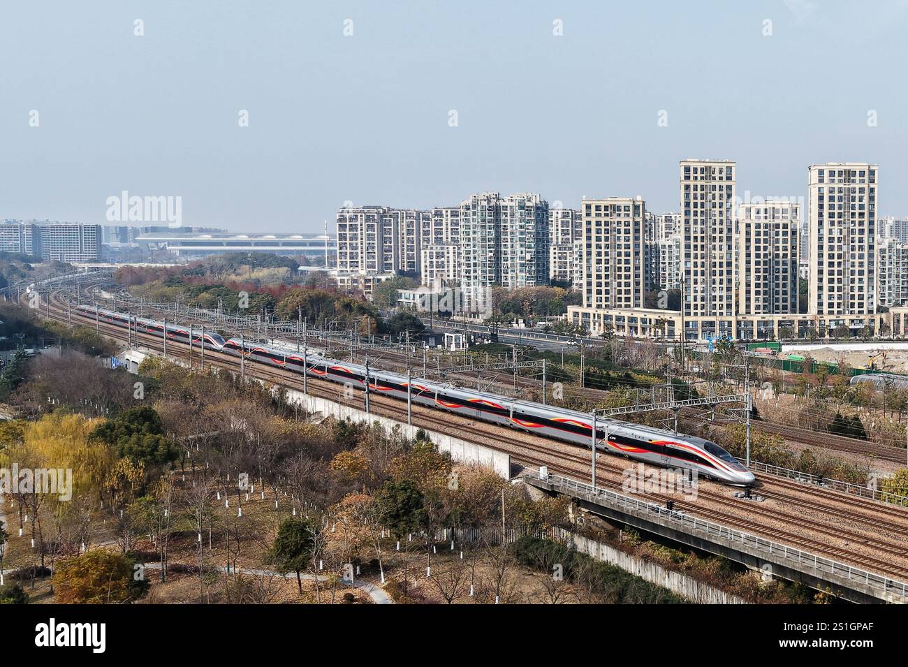 A high-speed train runs on a high-speed rail line in the main urban ...