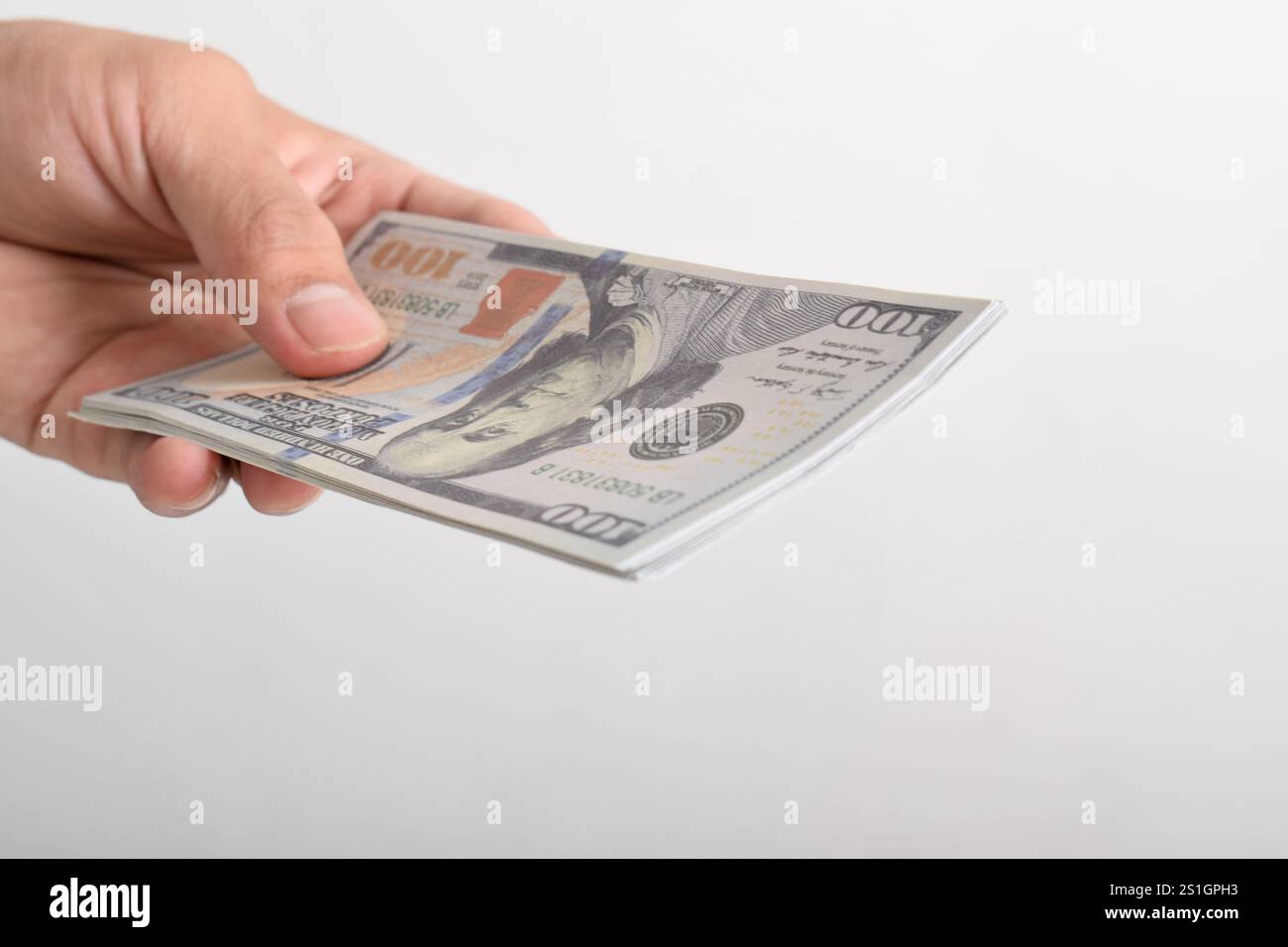 Man hand reaching out dollar bill. Hand holding dollar bill, US $100 ...