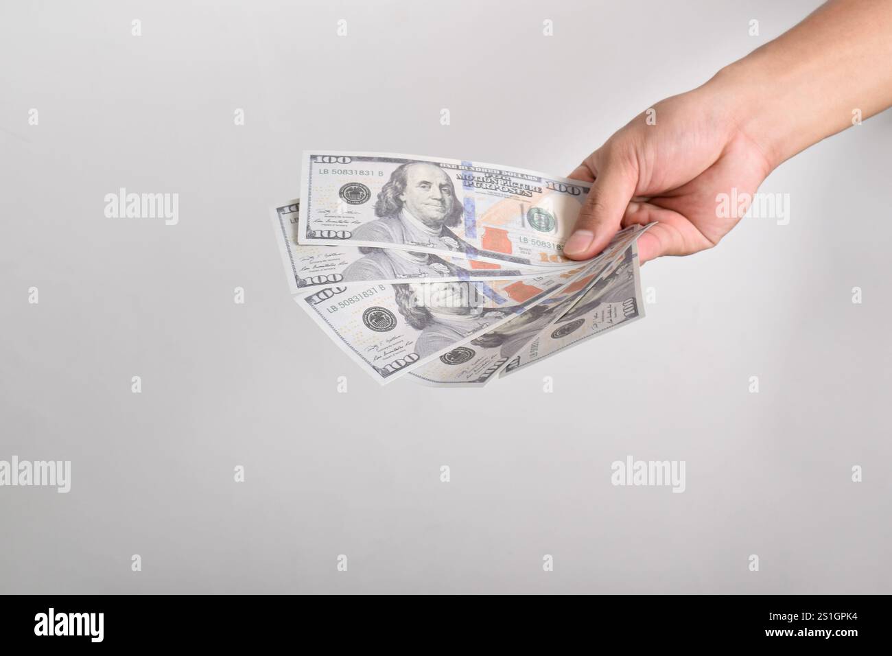 Man hand reaching out dollar bill. Hand holding dollar bill, US $100 ...