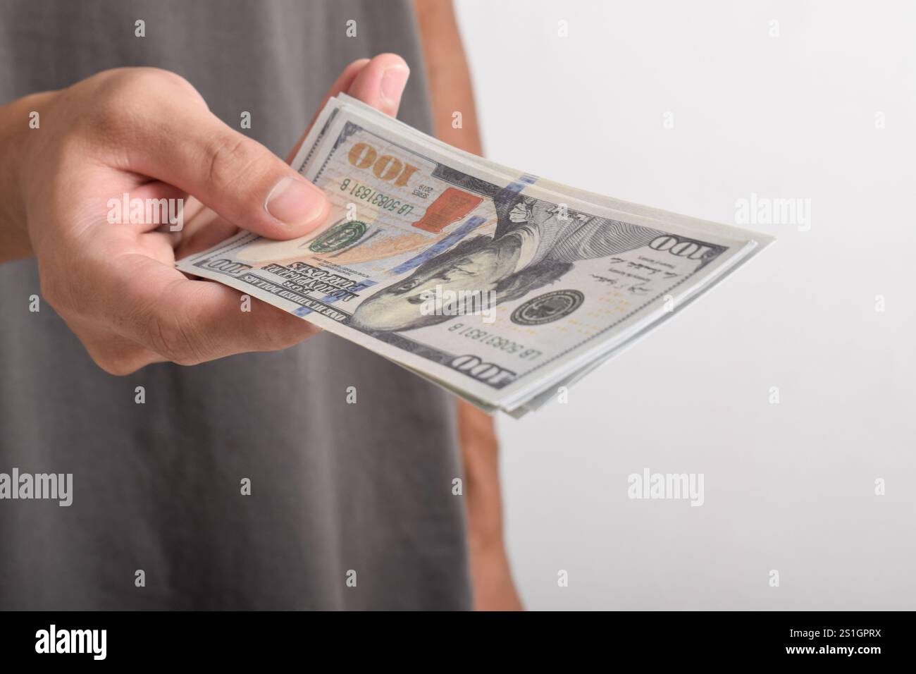 Man hand reaching out dollar bill. Hand holding dollar bill, US $100 ...
