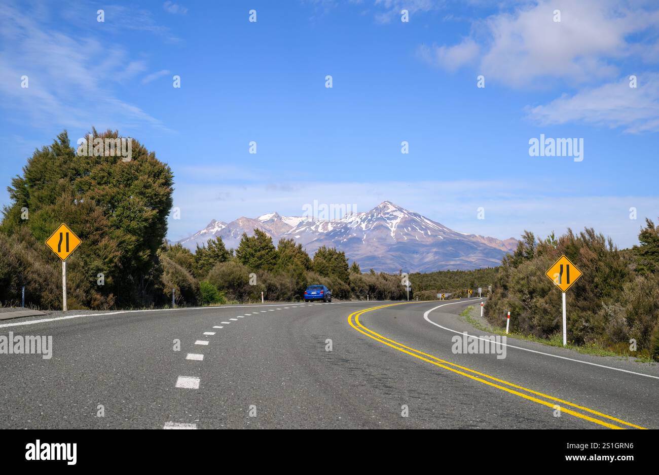 Road narrows on left road sign on Desert road. Mount Ruapehu in the ...
