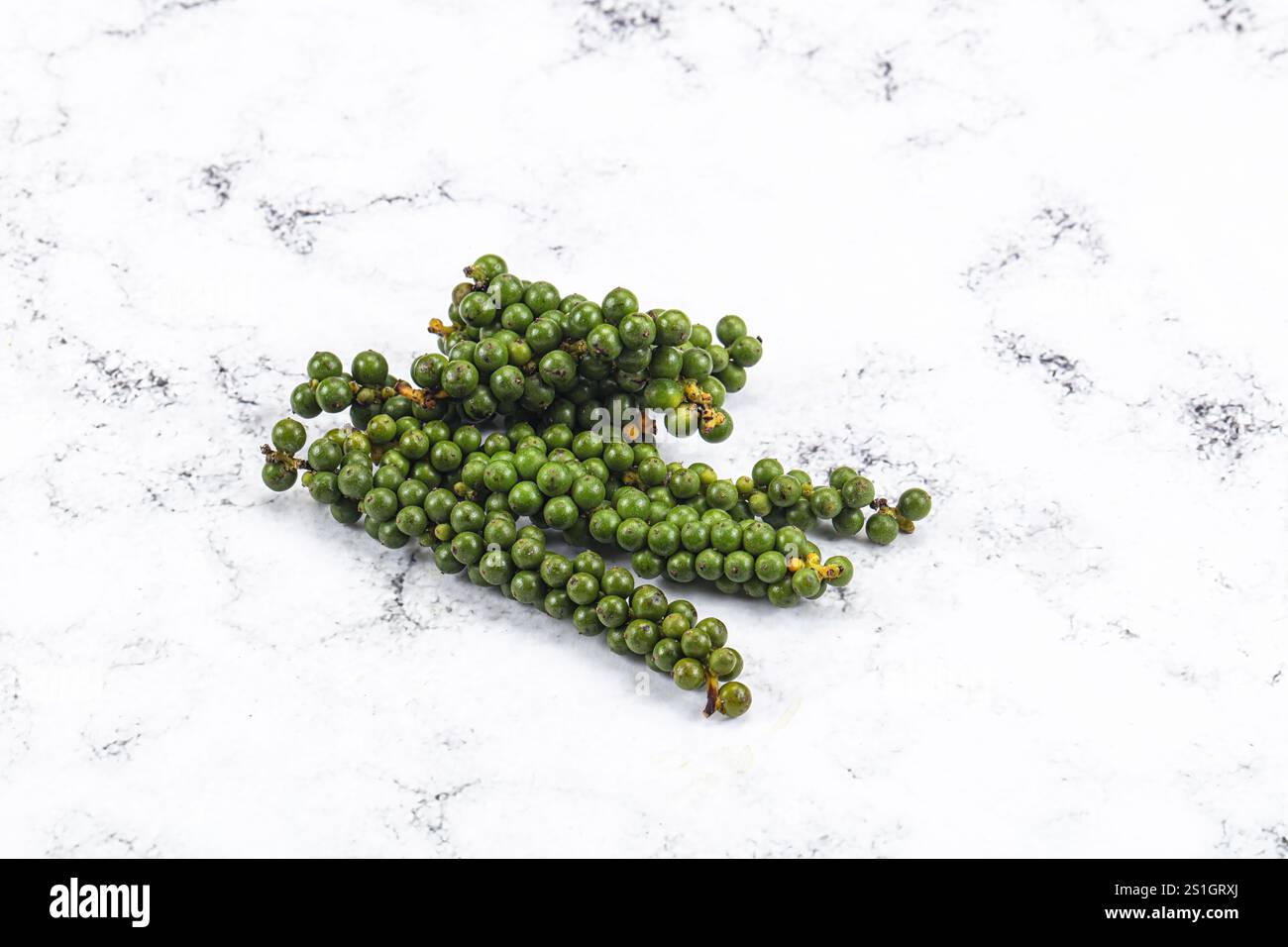 Green pepper corn on the branch heap Stock Photo - Alamy