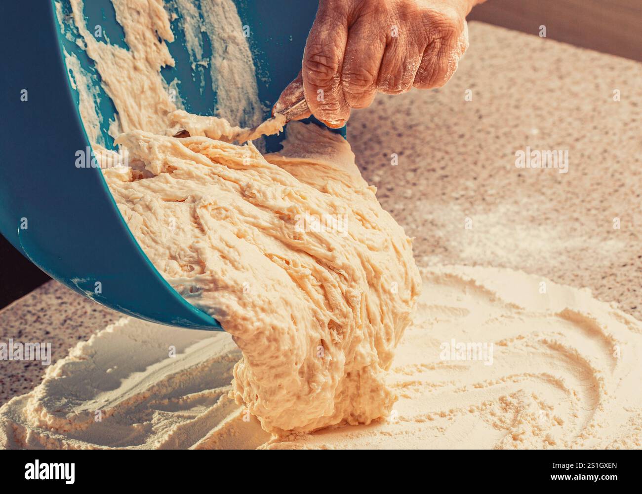 Woman kneading dough by hand yeast dough. Hand woman pours dough from a ...