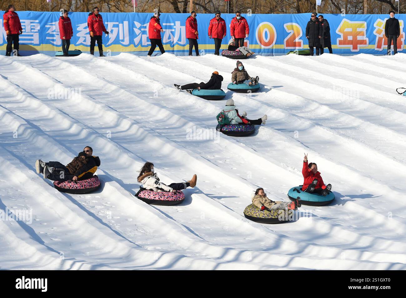 Beijing, China. 4th Jan, 2025. Visitors enjoy snow tubing at ...