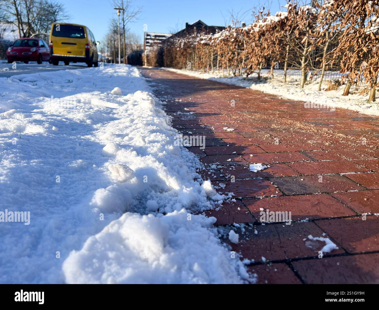 An icy pedestrian path sidewalk in winter with snow and sand Stock ...
