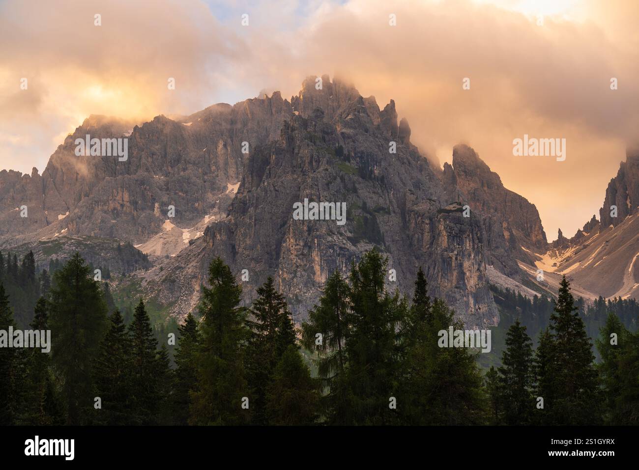 Mountains in sunset. Majestic rocky peaks are illuminated by soft ...