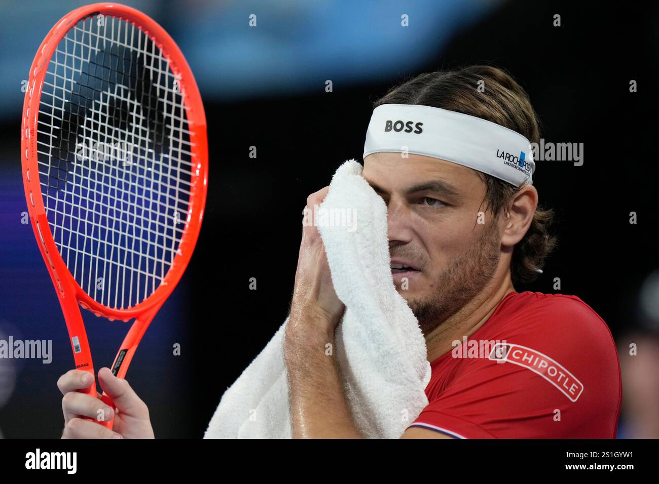 Taylor Fritz of the U.S. uses a towel during a break while playing ...