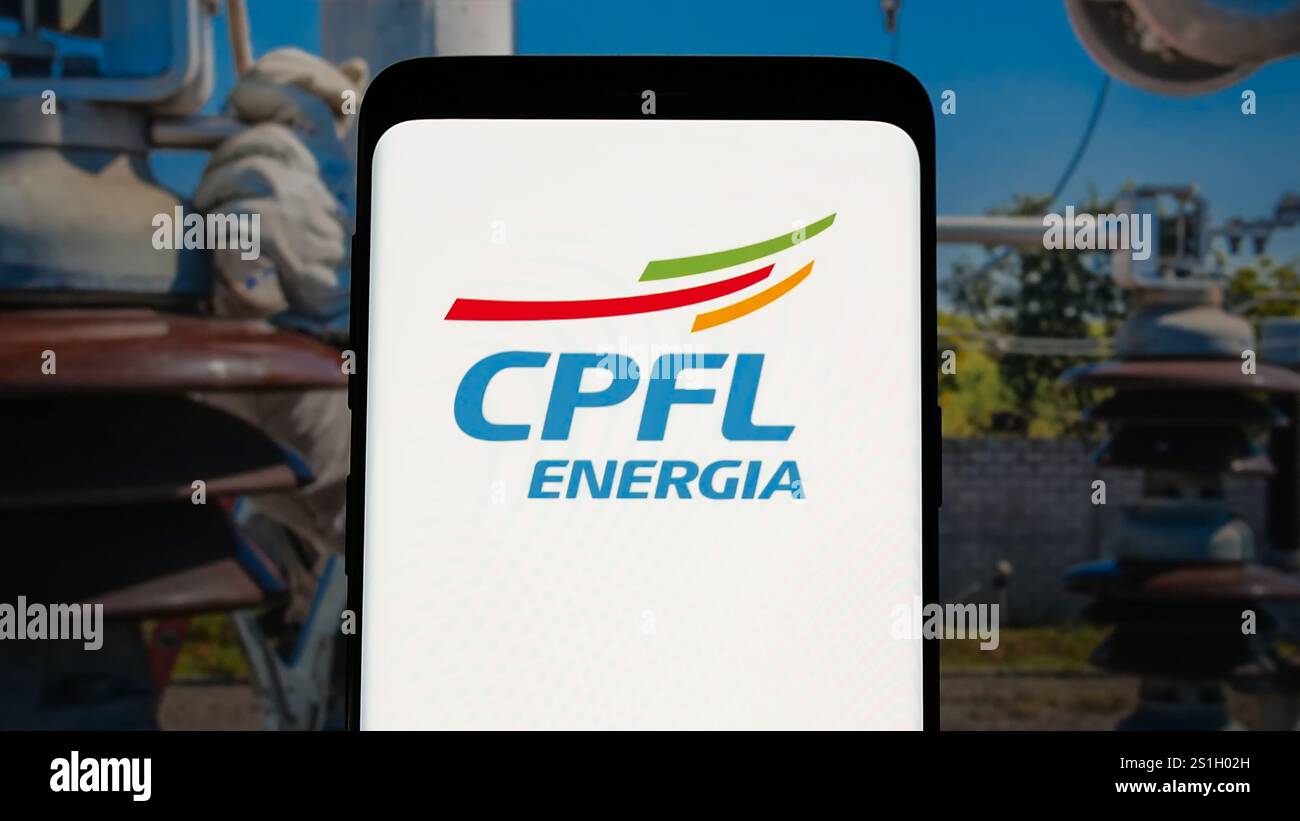 In this photo illustration, a smartphone with the logo of Brazilian energy company CPFL Energia ...