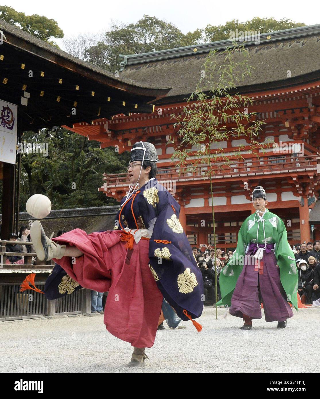 People clad in traditional attire play "kemari," a football game played ...