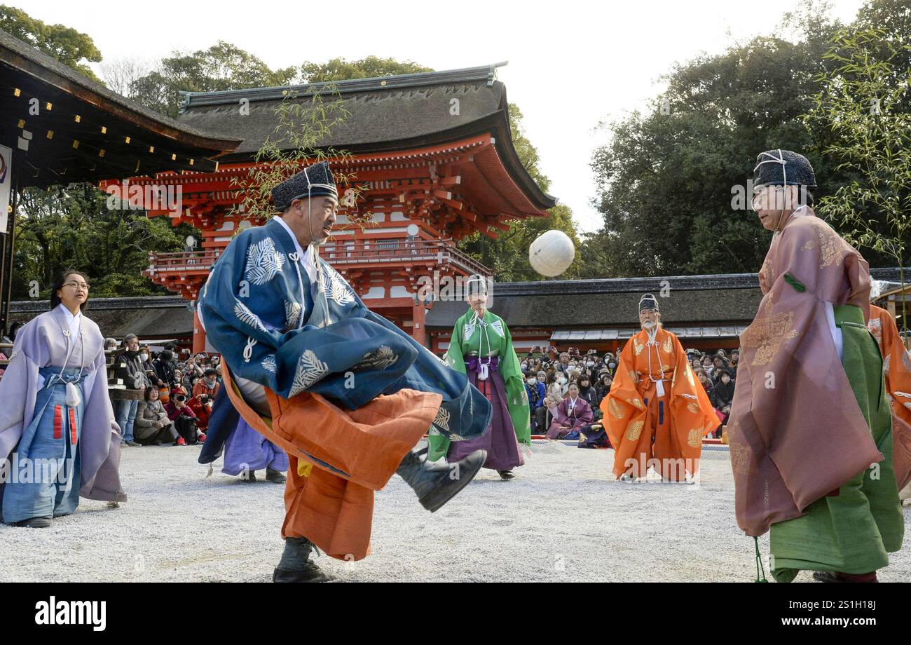 People clad in traditional attire play "kemari," a football game played ...
