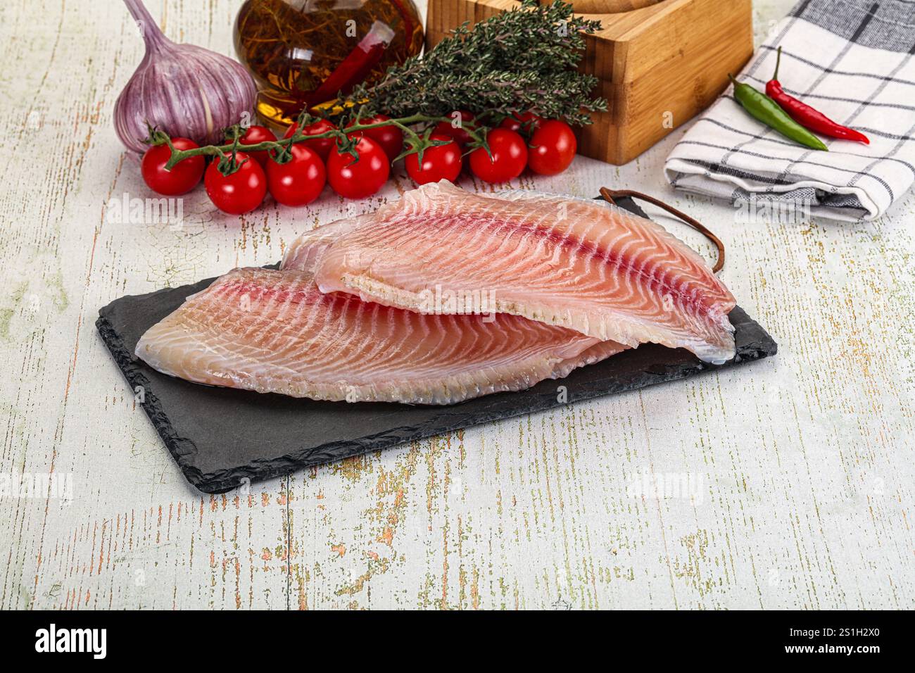 Raw Tilapia fish fillet slice uncooked Stock Photo - Alamy
