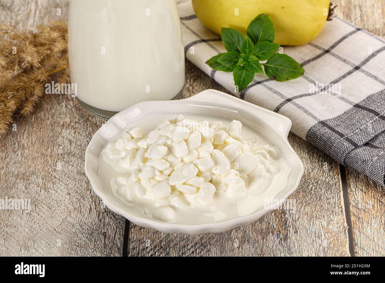 Grain cottage cheese with sour in the bowl Stock Photo - Alamy