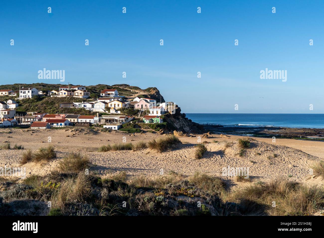 Traditional Monte Clerigo beach colourful portuguese houses on the ...