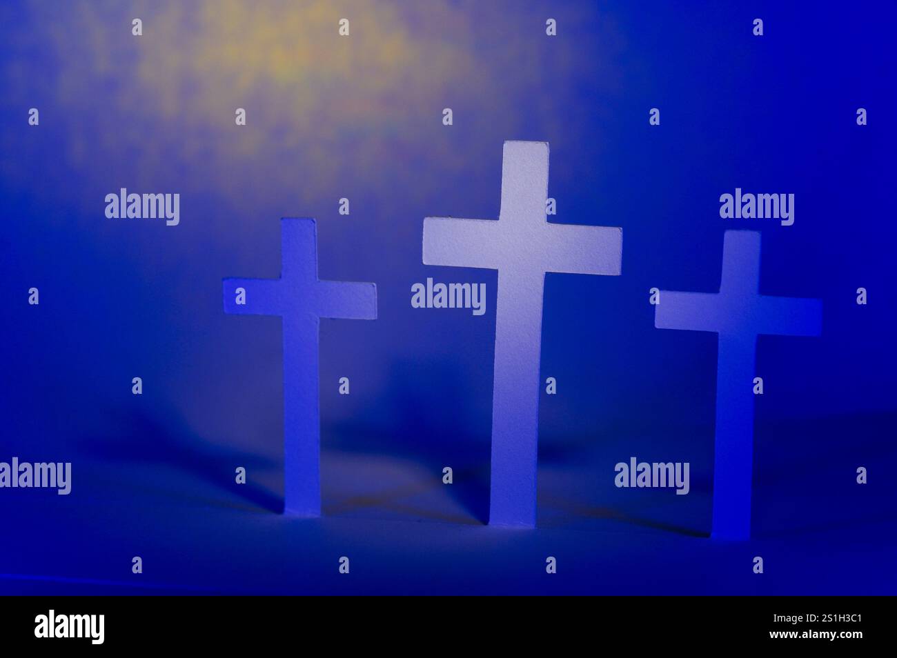 Three crosses with highlight on center cross on a yellow blue ...