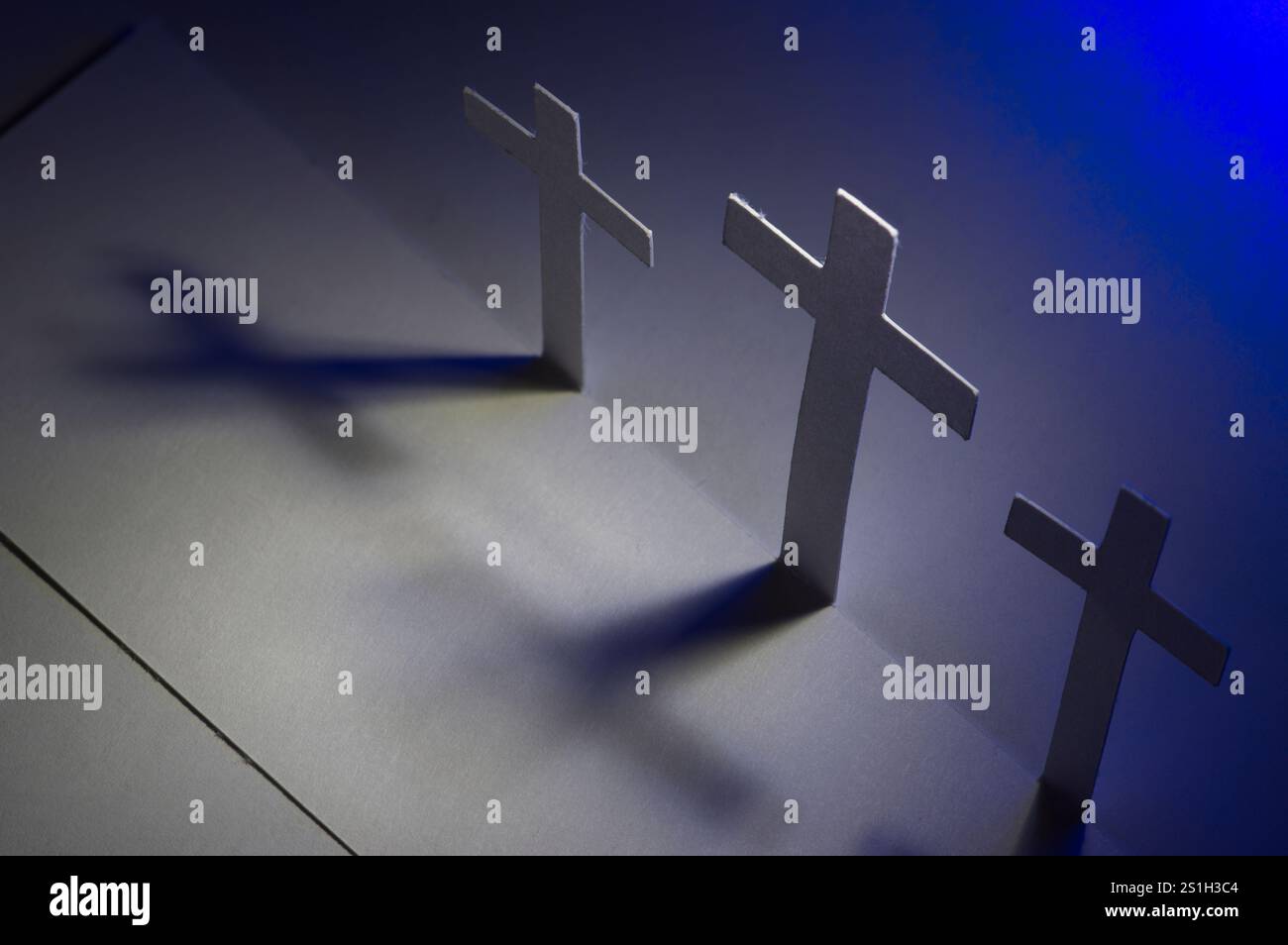 Three crosses with blue backlight and forward shadows Stock Photo - Alamy