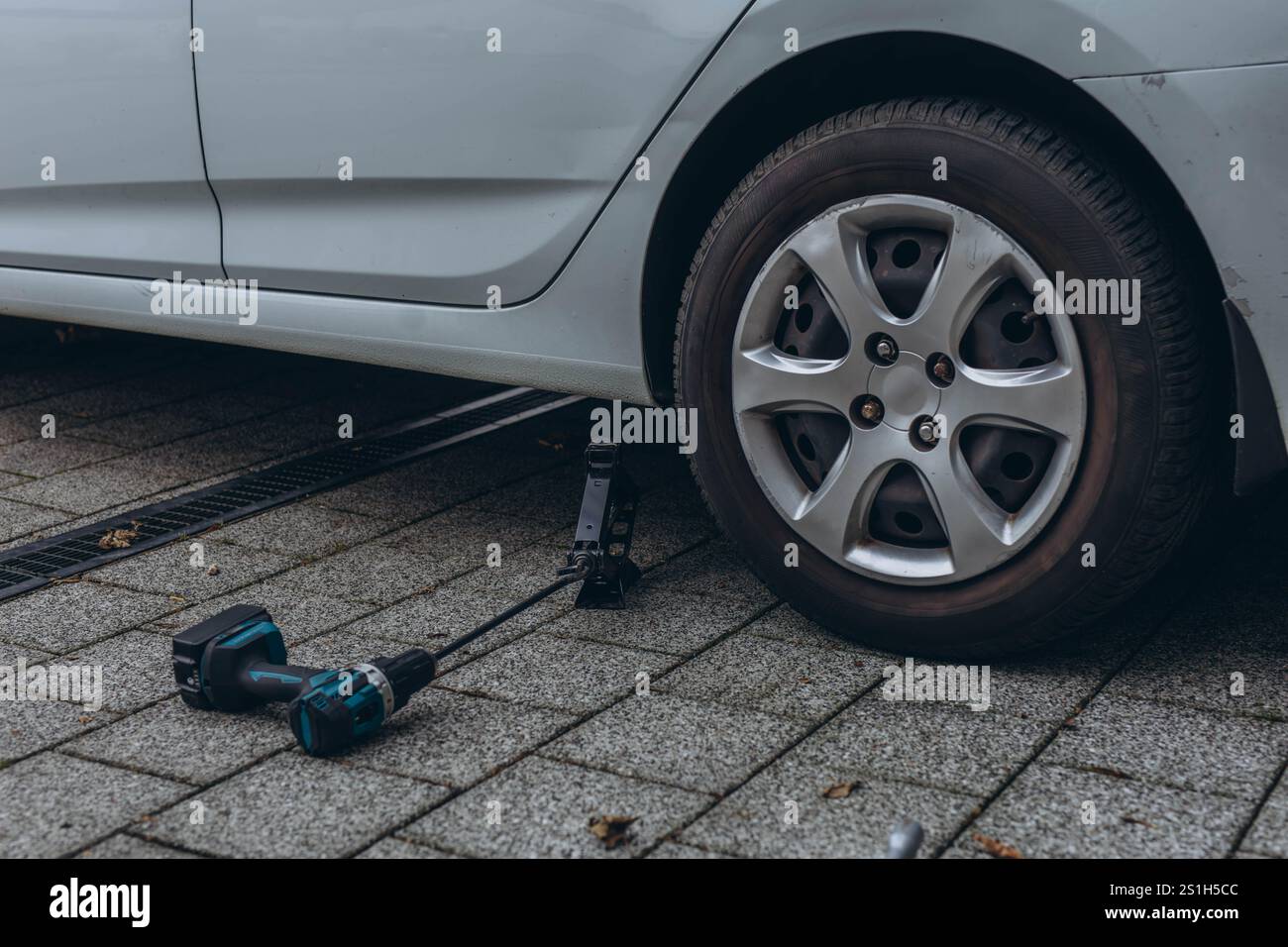 Emergency situation with a car, replacing a tire on the roadside. High ...