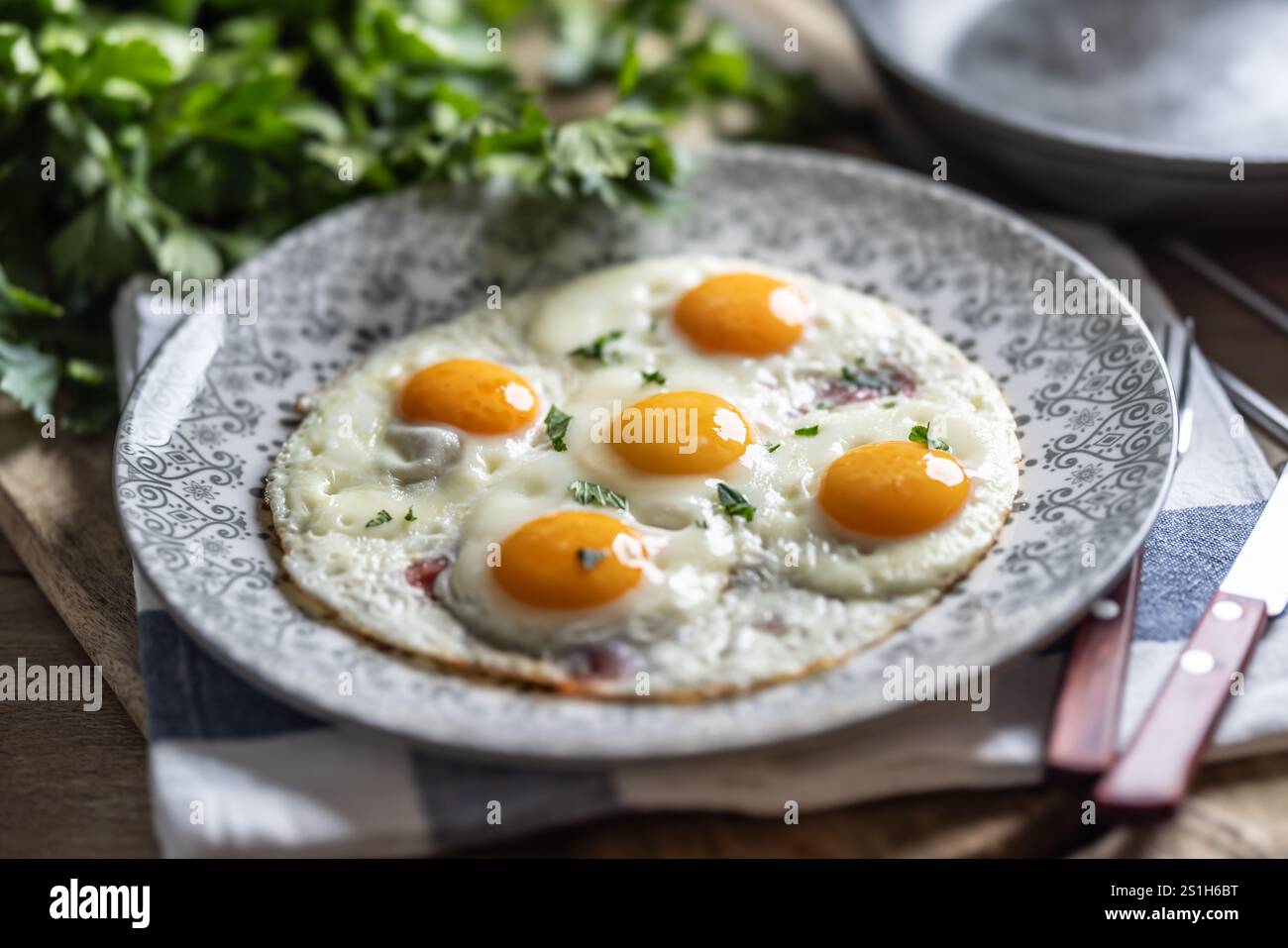English breakfast on a plate. Ham and eggs sprinkled with parsley Stock ...