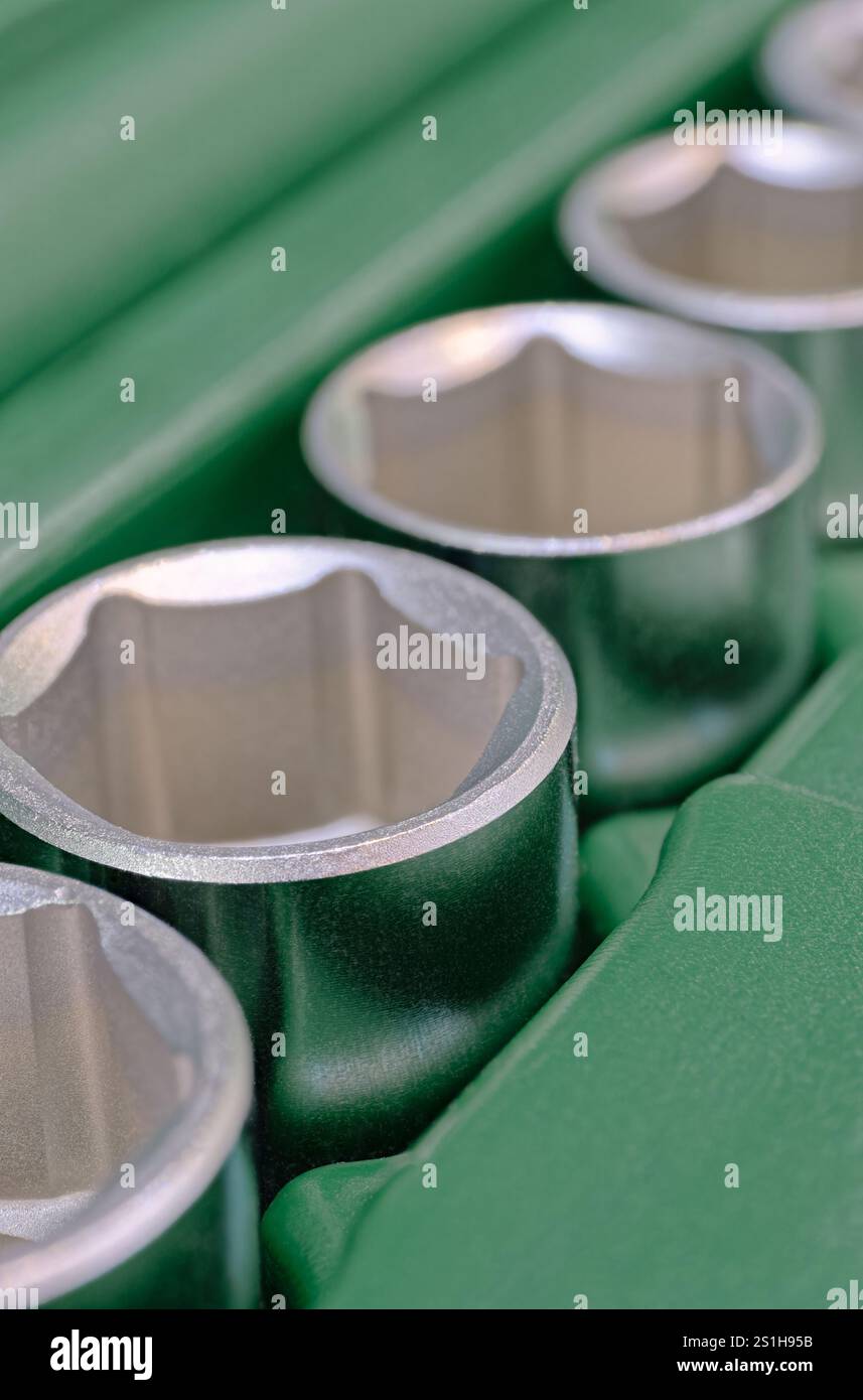 Set of shiny steel hexagonal sockets for wrench in a plastic toolbox ...