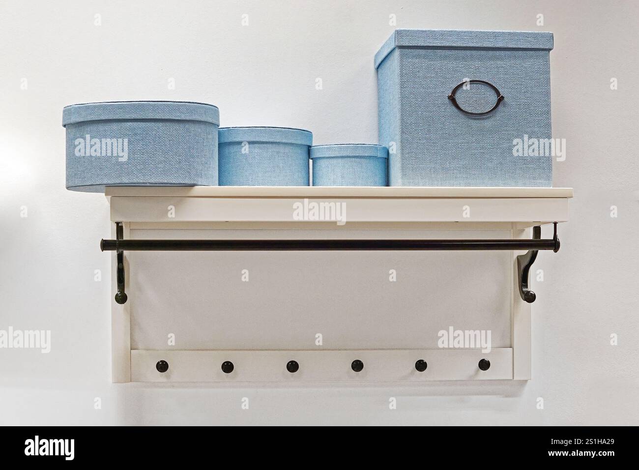 Decorative storage boxes at rack shelf in home Stock Photo - Alamy