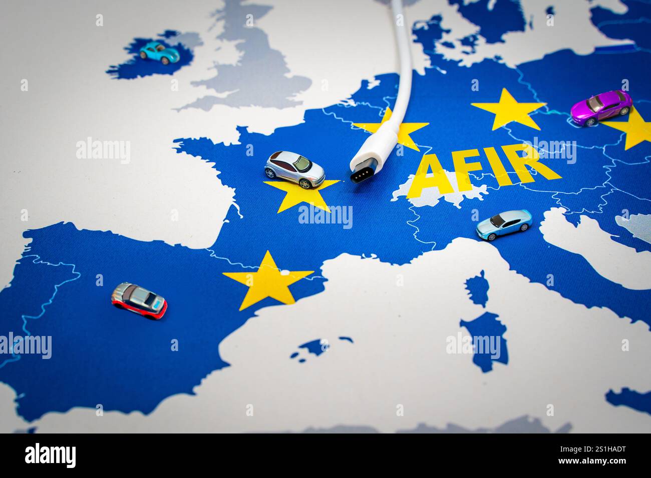 Electric toy cars and charging cable on european union flag map ...