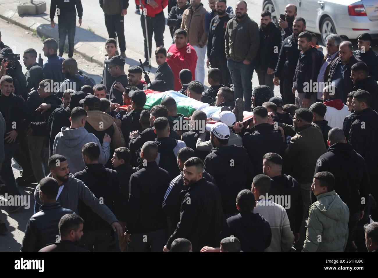 People attend the funeral of 18 years old Mohamad Amir who was shot ...