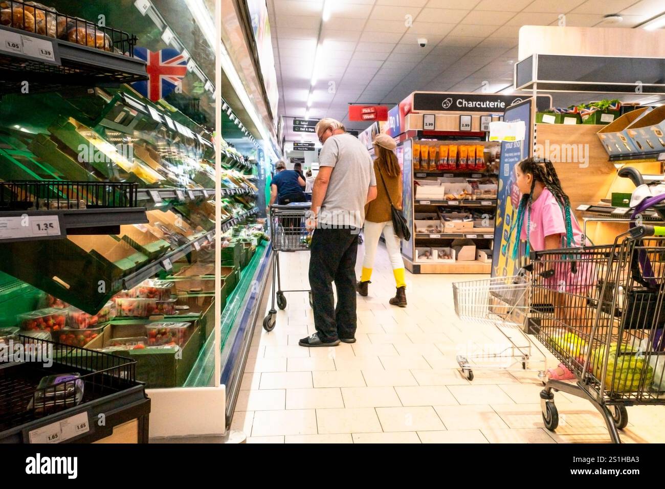 Shoppers customers people shopping inside a Lidl shop store in England ...