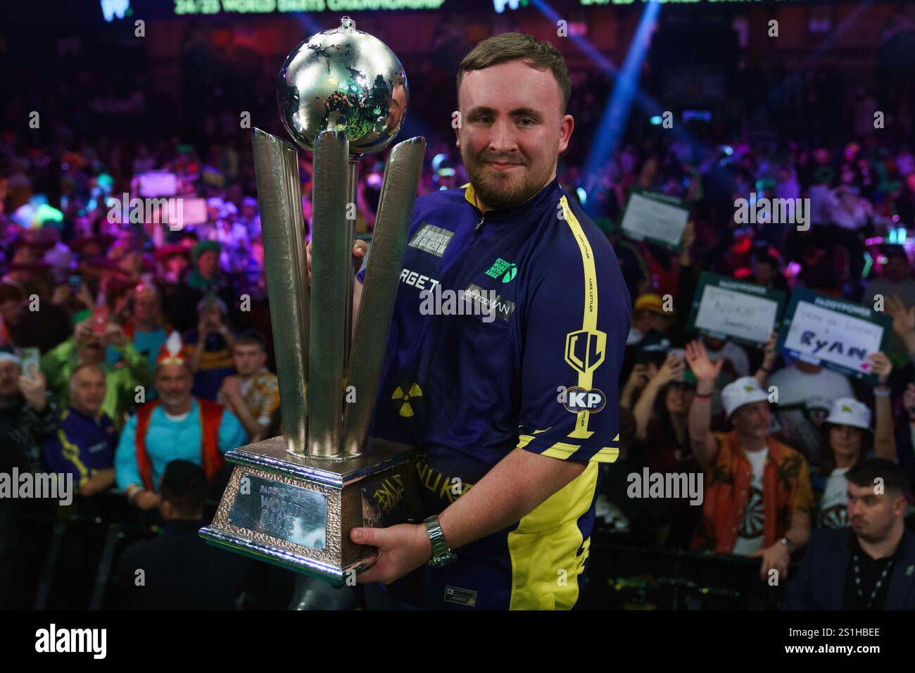 Luke Littler lifting the Paddy Power World Darts Championship trophy ...