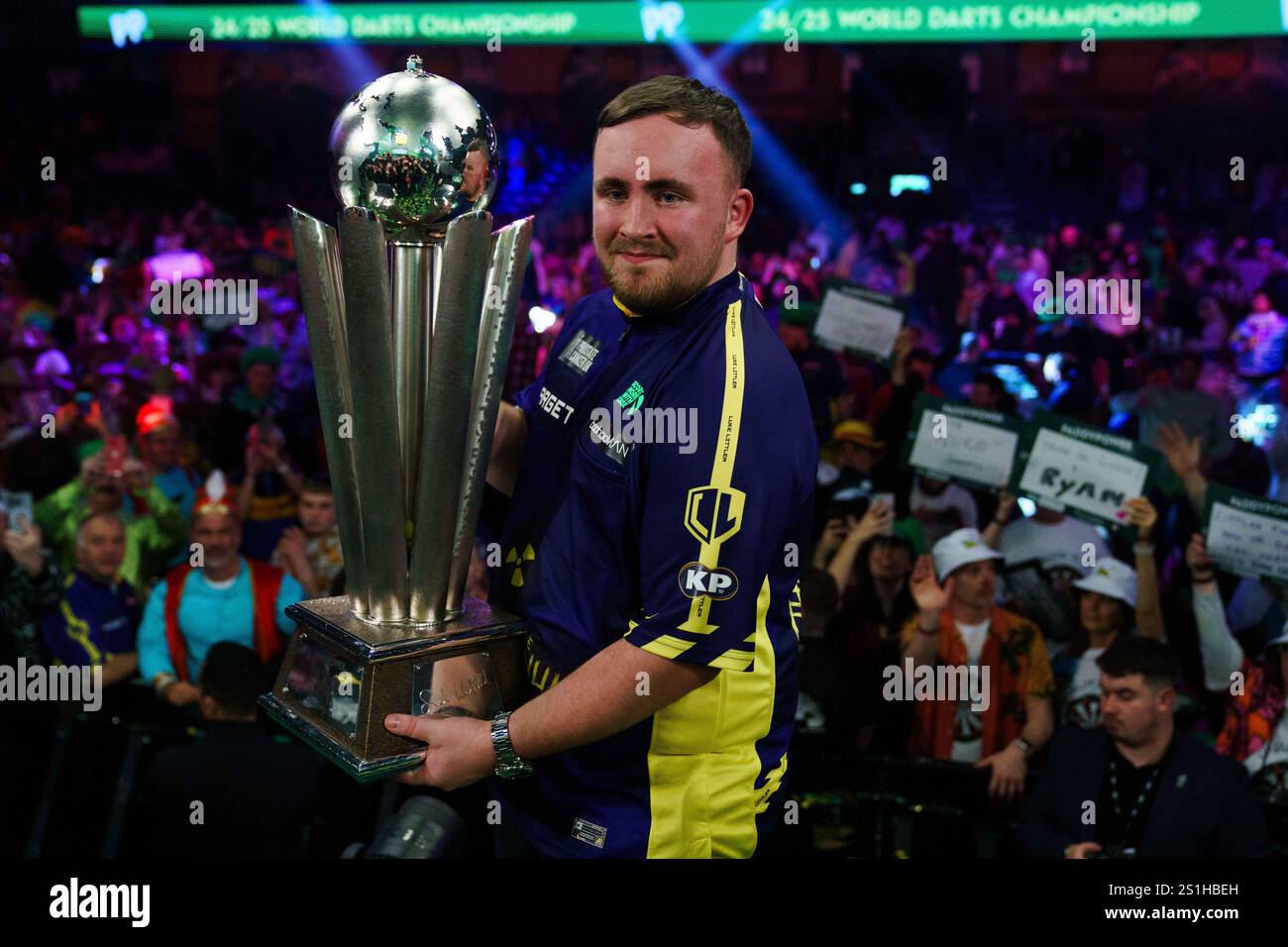 Luke Littler lifting the Paddy Power World Darts Championship trophy ...