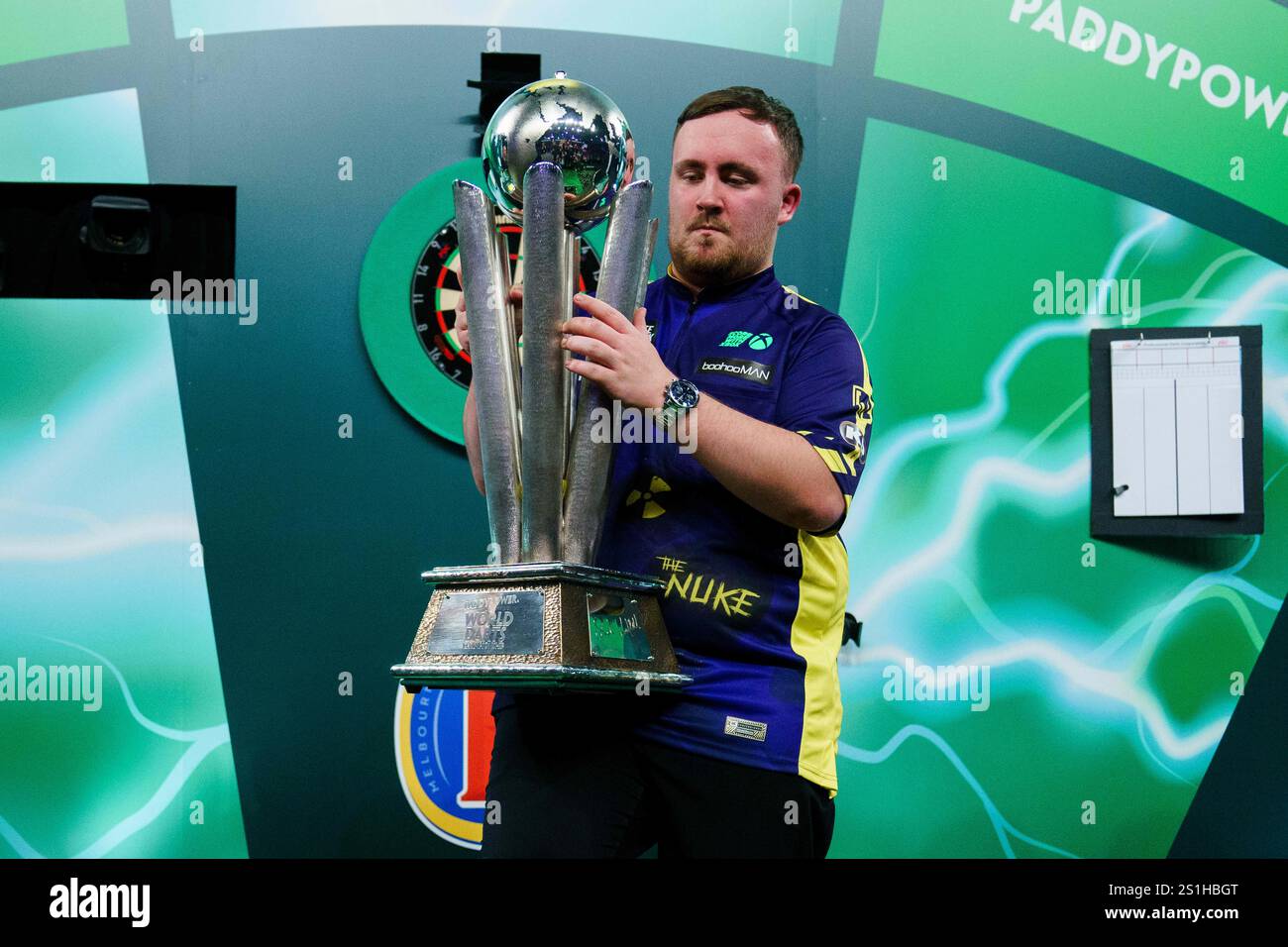 Luke Littler lifting the Paddy Power World Darts Championship trophy ...