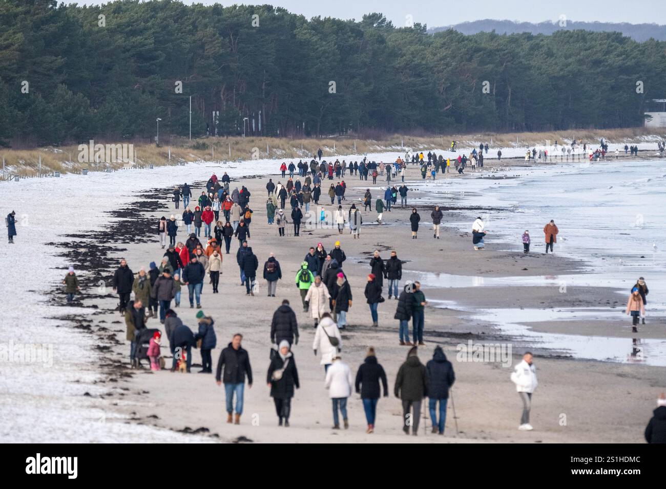 Binz, Germany. 04th Jan, 2025. Walkers take advantage of the sunny ...