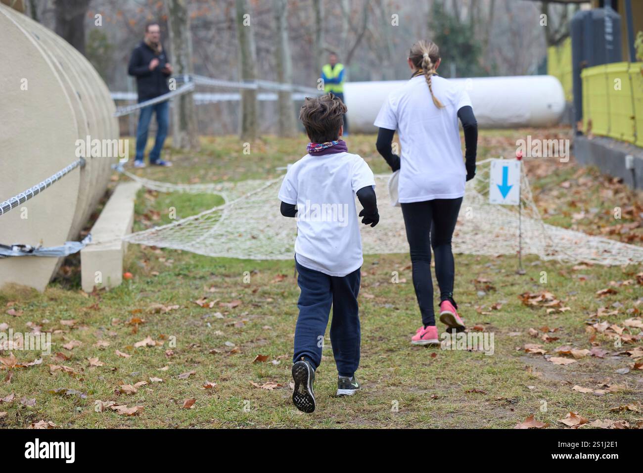Two people participate in the II Three Kings Popular Obstacle Race, at ...