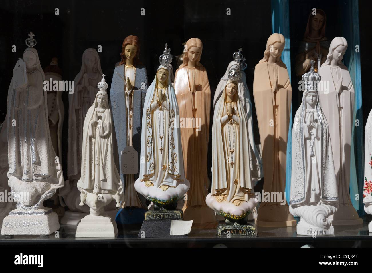 Our lady of Fatima catholic religious Virgin Mary statue in the window of the souvenir shop in ...