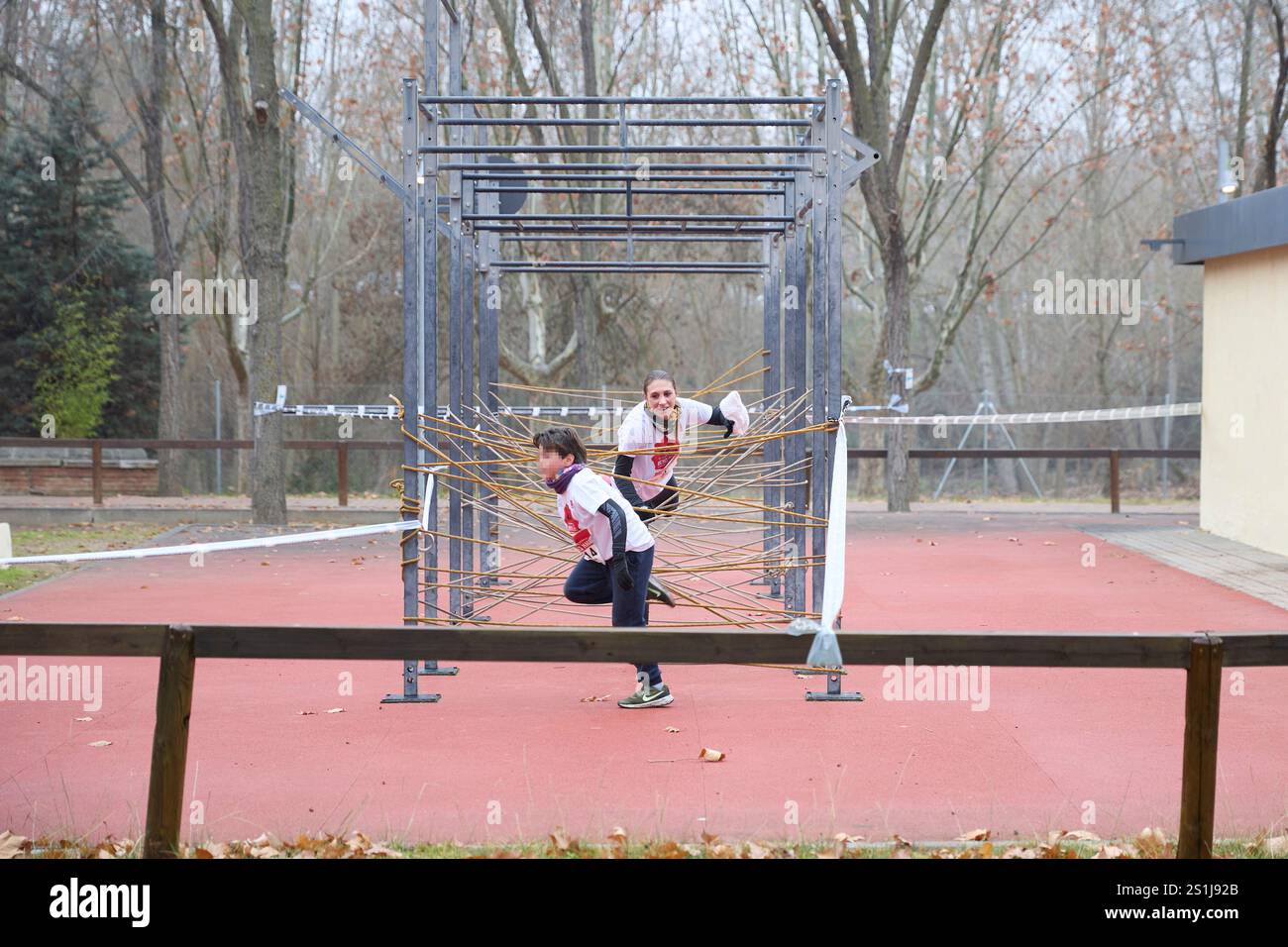 Two people participate in the II Three Kings Popular Obstacle Race, at ...