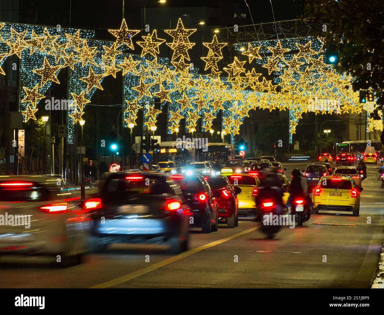 Athens, Greece - January 3, 2025: Urban street at night with holiday ...