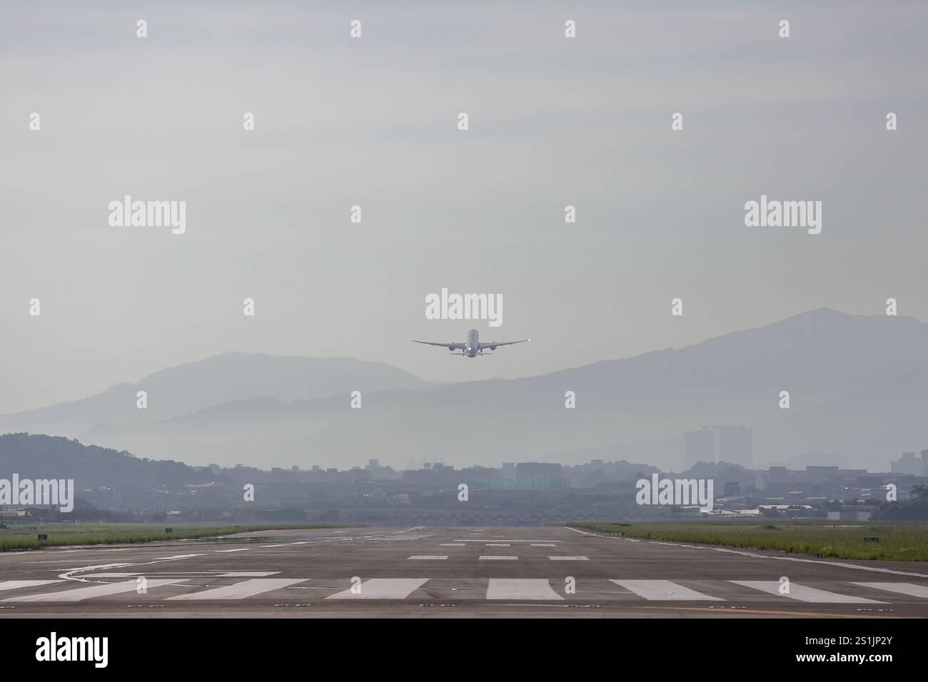 An airplane taking off from an airport in the morning Stock Photo - Alamy