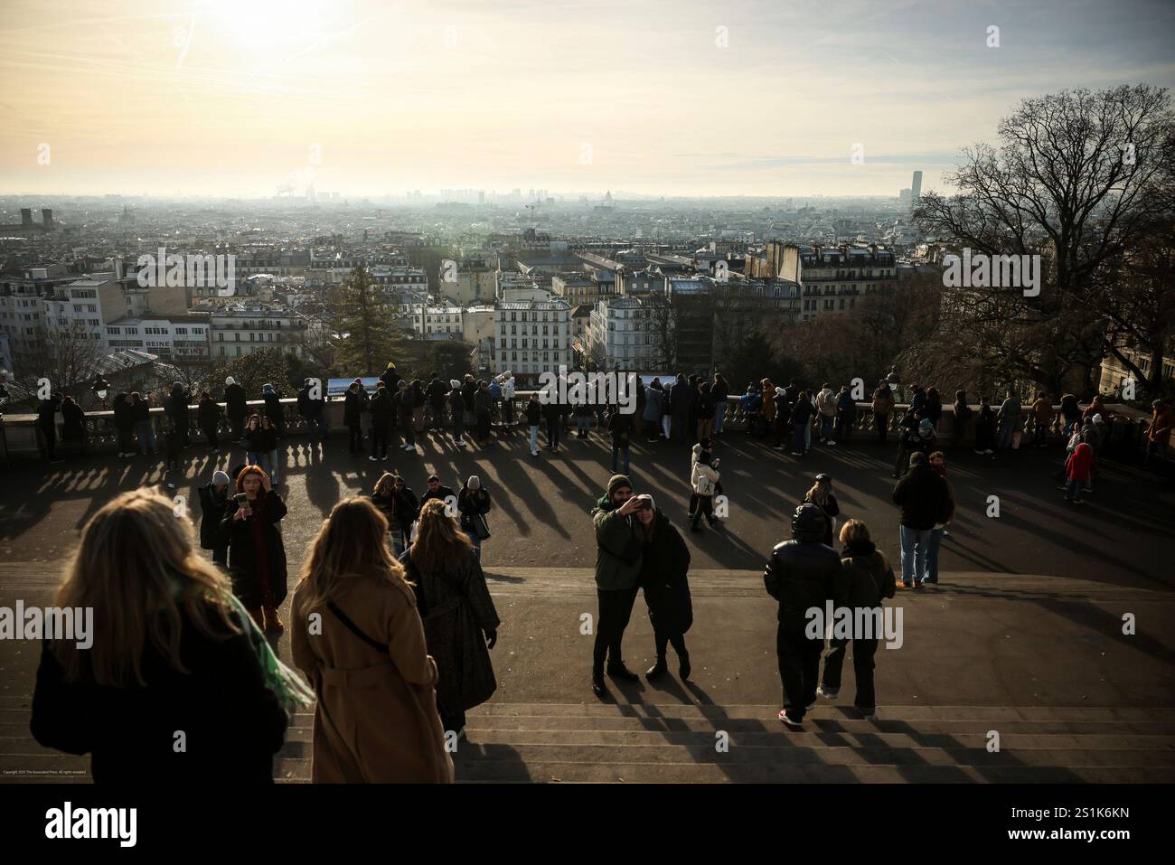 People look at the view of Paris from Montmartre on a cold day in Paris ...