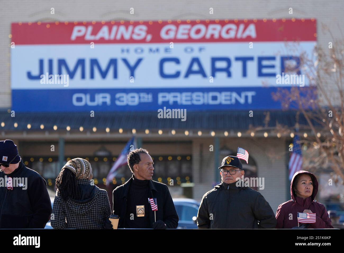 People wait for a funeral procession for former President Jimmy Carter ...