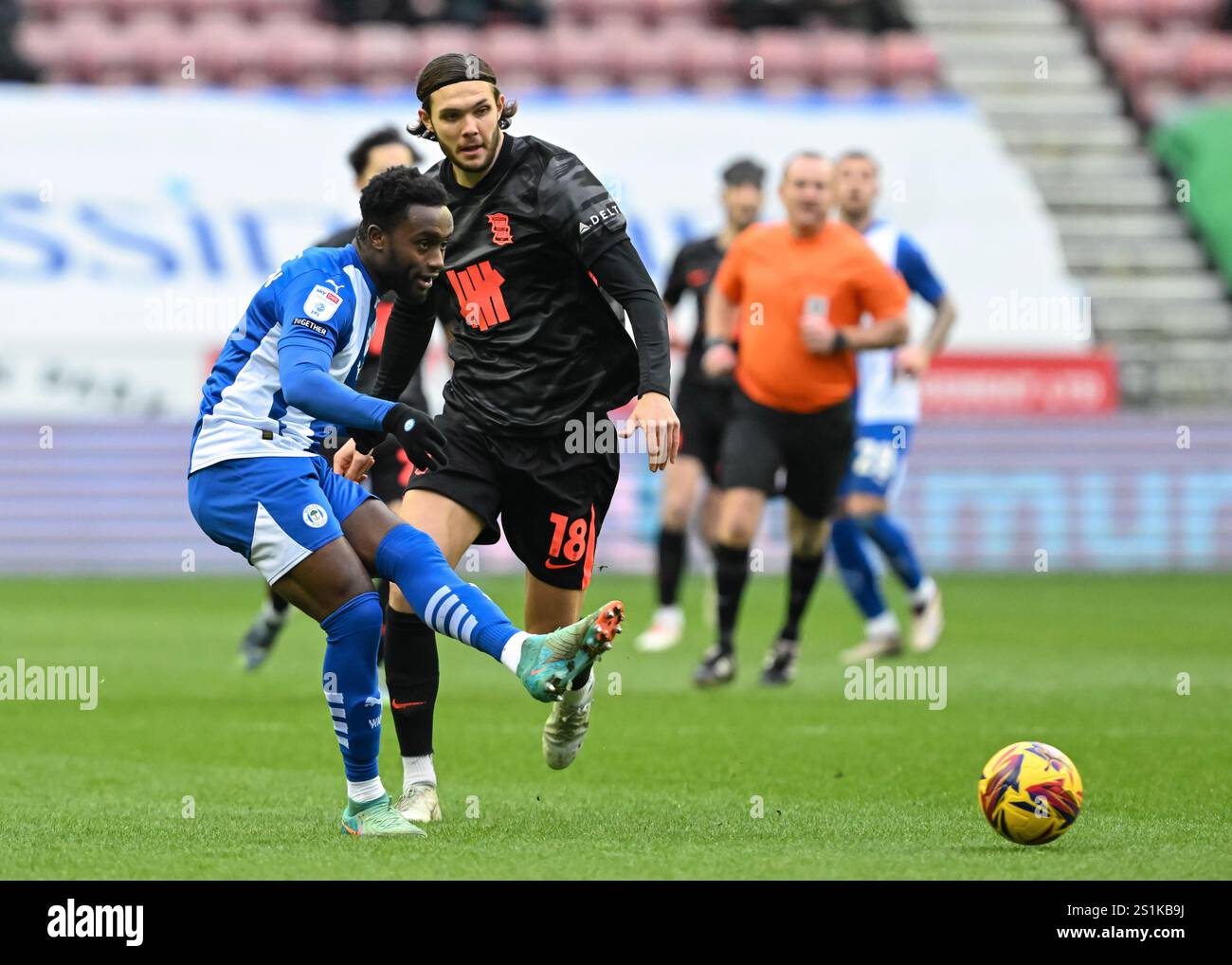 Wigan Athletic's Steven Sessegnon passes the ball while under pressure ...