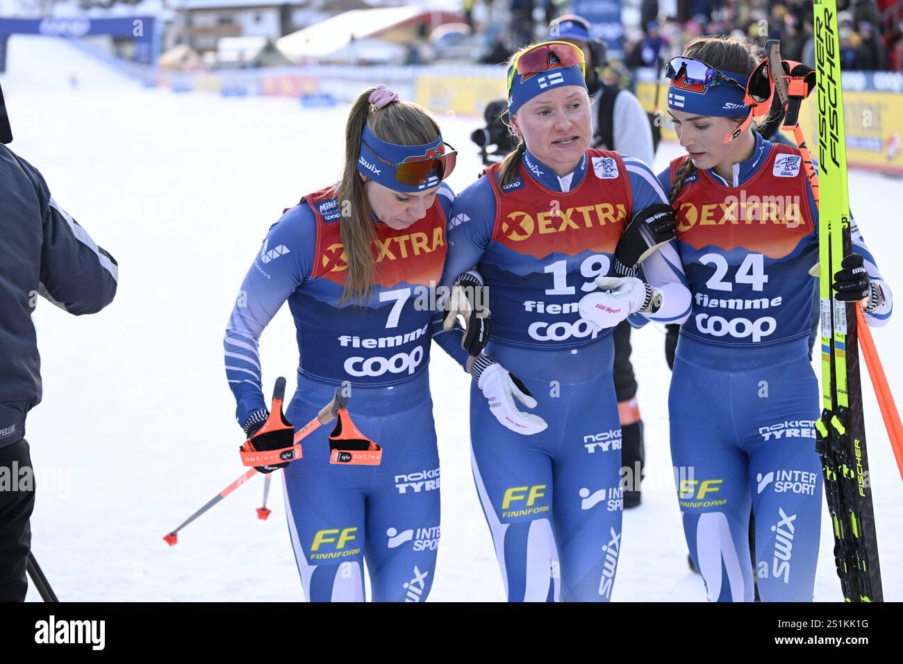 Jasmi Joensuu (L) and Jasmin Kähärä (R) help Johanna Matintalo, all of Finland, after competing ...