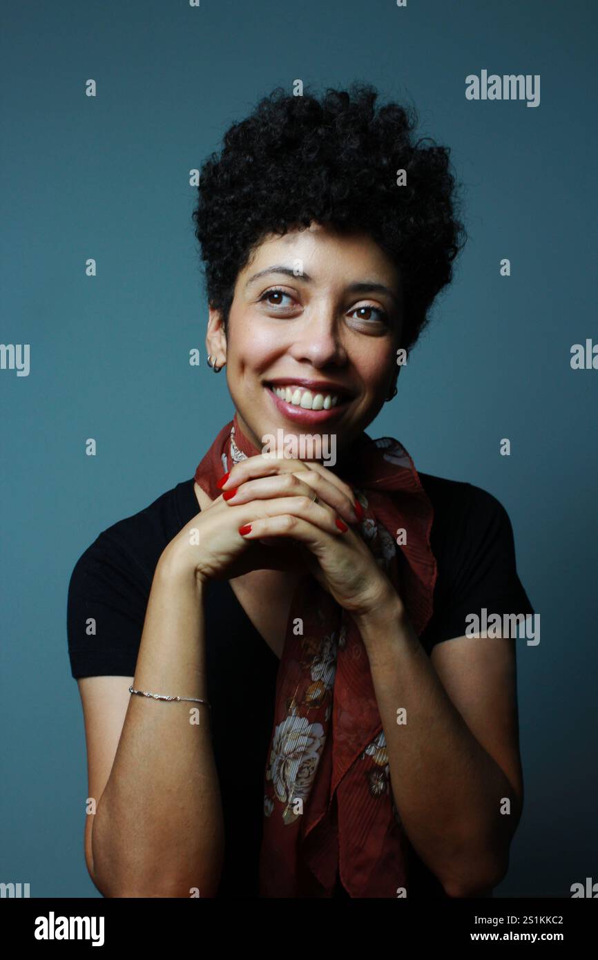 Short curly hair black Brazilian woman daydreaming, wearing black shirt ...