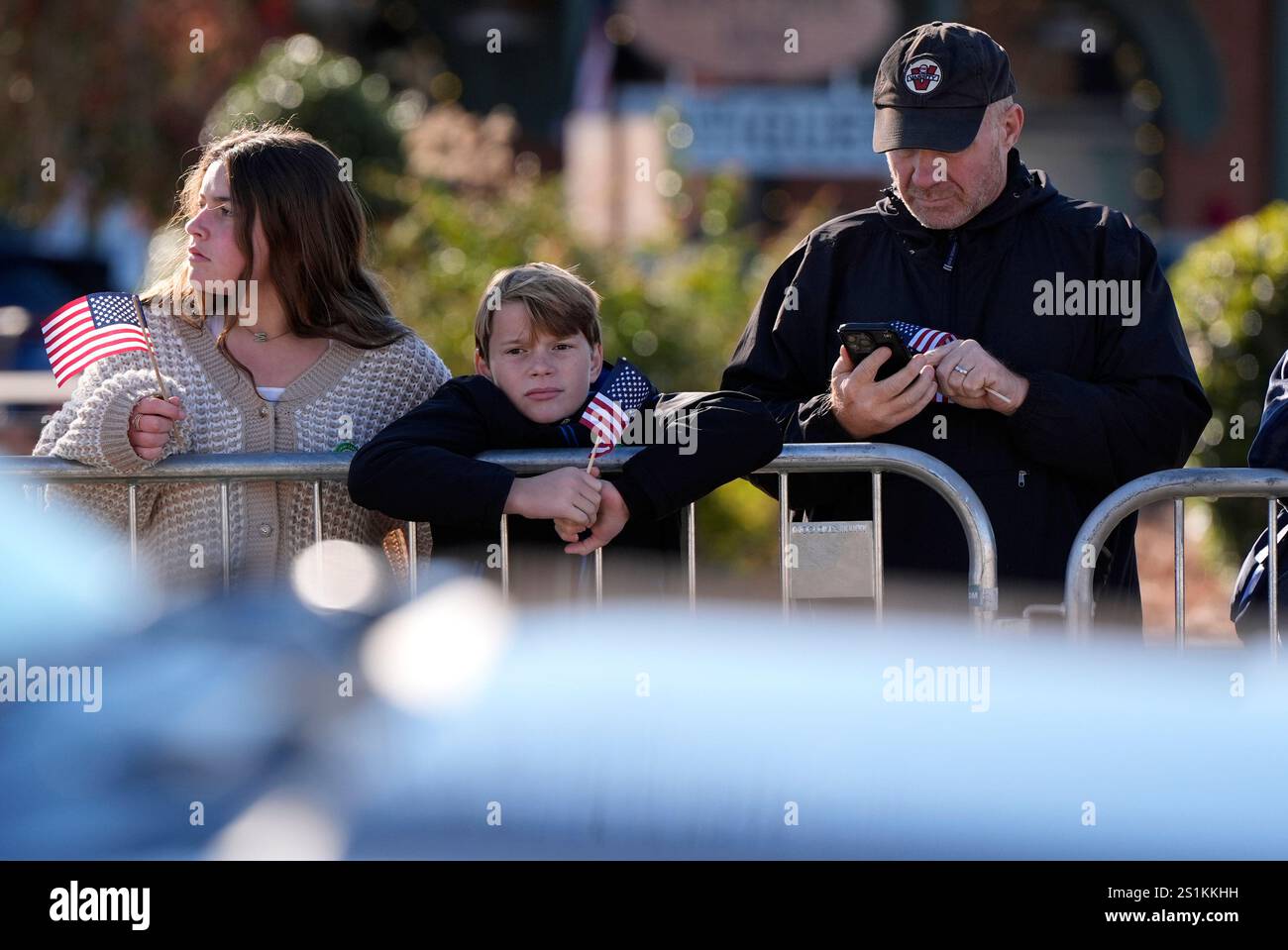 People watch as a hearse carrying the flag-draped casket of former ...