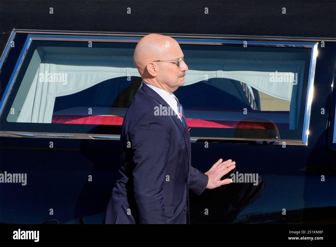 A U.S. Secret Service agent assigned to the Carter detail touches the ...