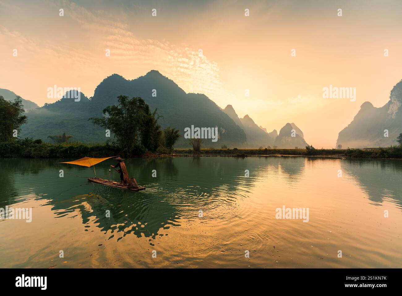 Fisherman villager with traditional fishing on bamboo raft over the ...