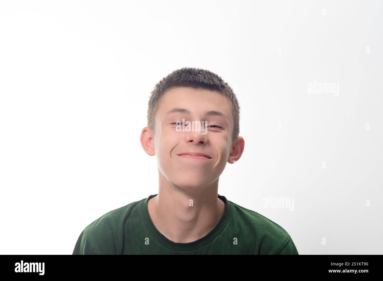 Close-up portrait of a cheerful teenage boy with short brown hair ...
