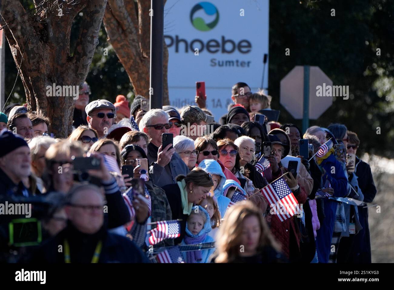 People watch before the hearse carrying the flag-draped casket of ...