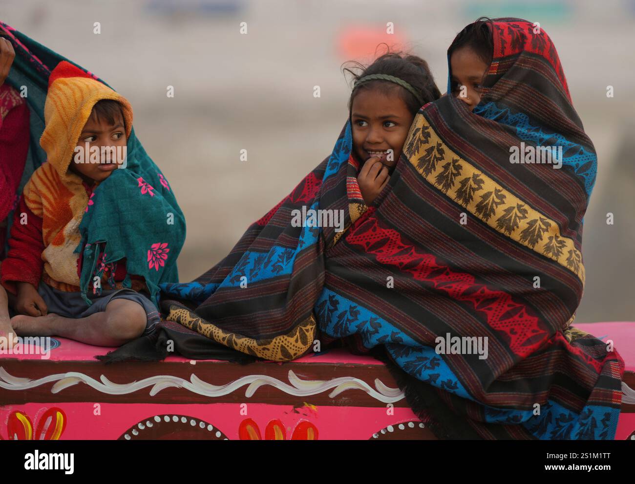 Indian children wrapped in blankets against the cold weather in ...