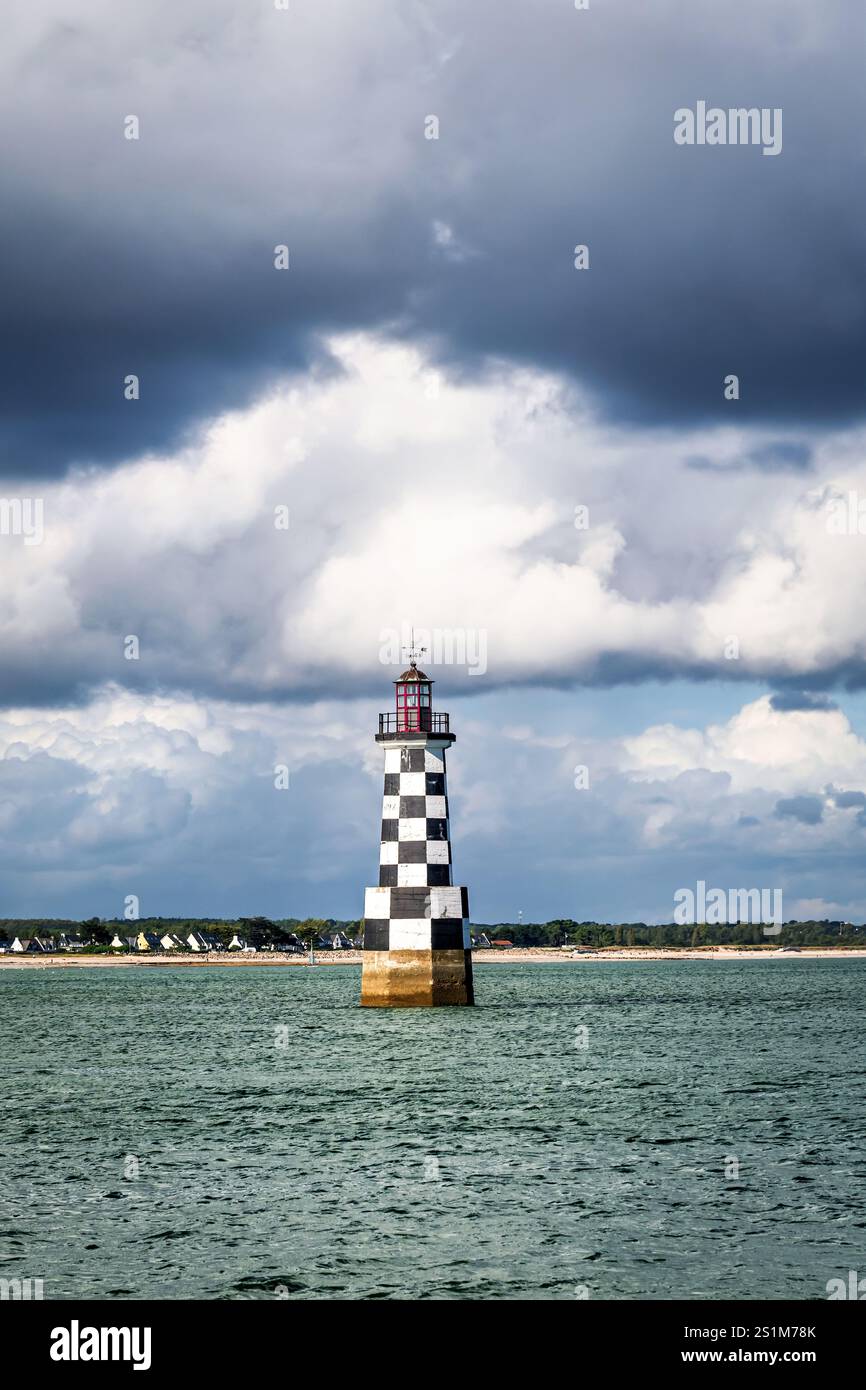 Checkerboard lighthouse of Ile Tudy in Brittany in France on a very ...