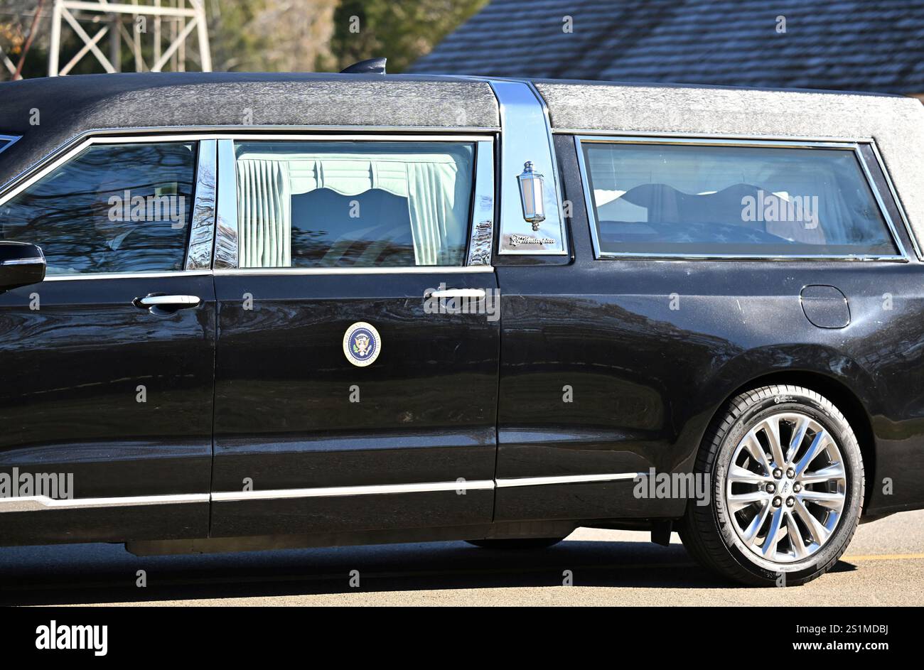 The hearse carrying the flag-draped casket of former President Jimmy Carter arrives at the Jimmy ...